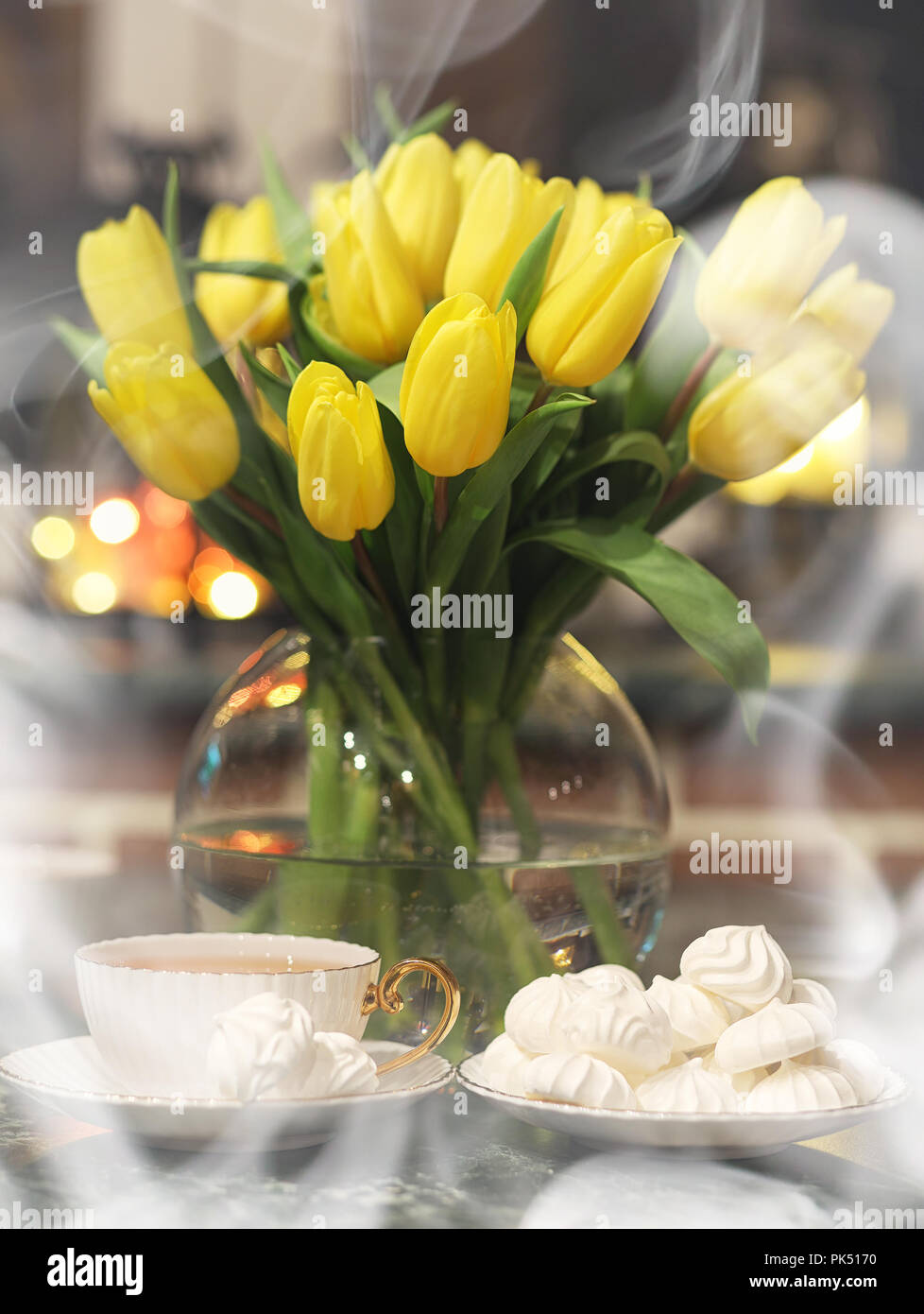 A bouquet of yellow tulips in a vase in the interior of a retro Stock ...
