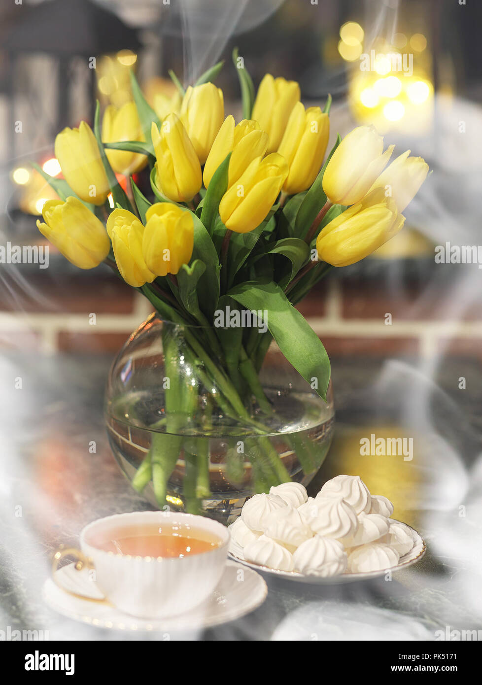 A bouquet of yellow tulips in a vase in the interior of a retro Stock ...