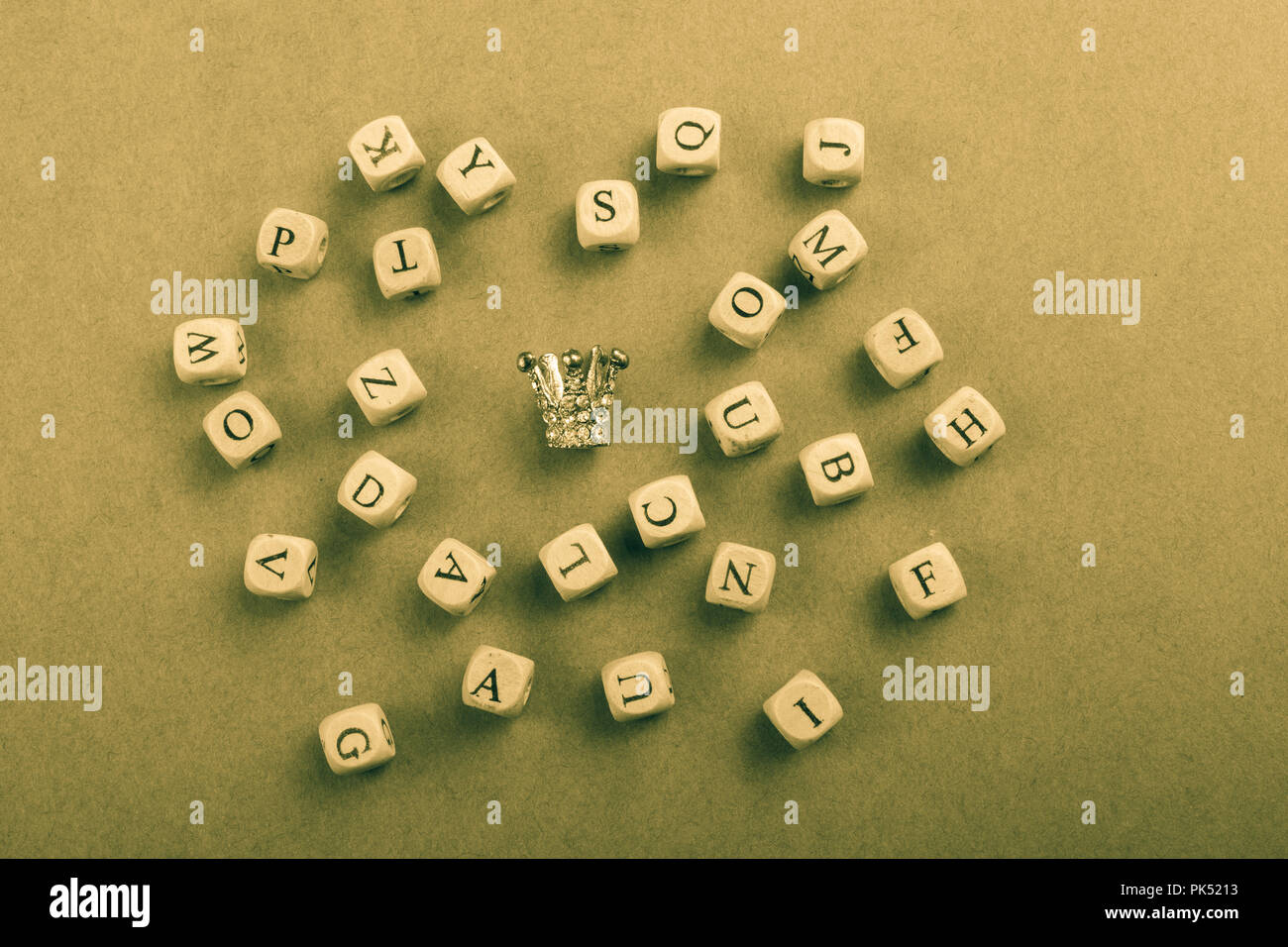 Letter cubes of Alphabet made of wood around crown Stock Photo - Alamy