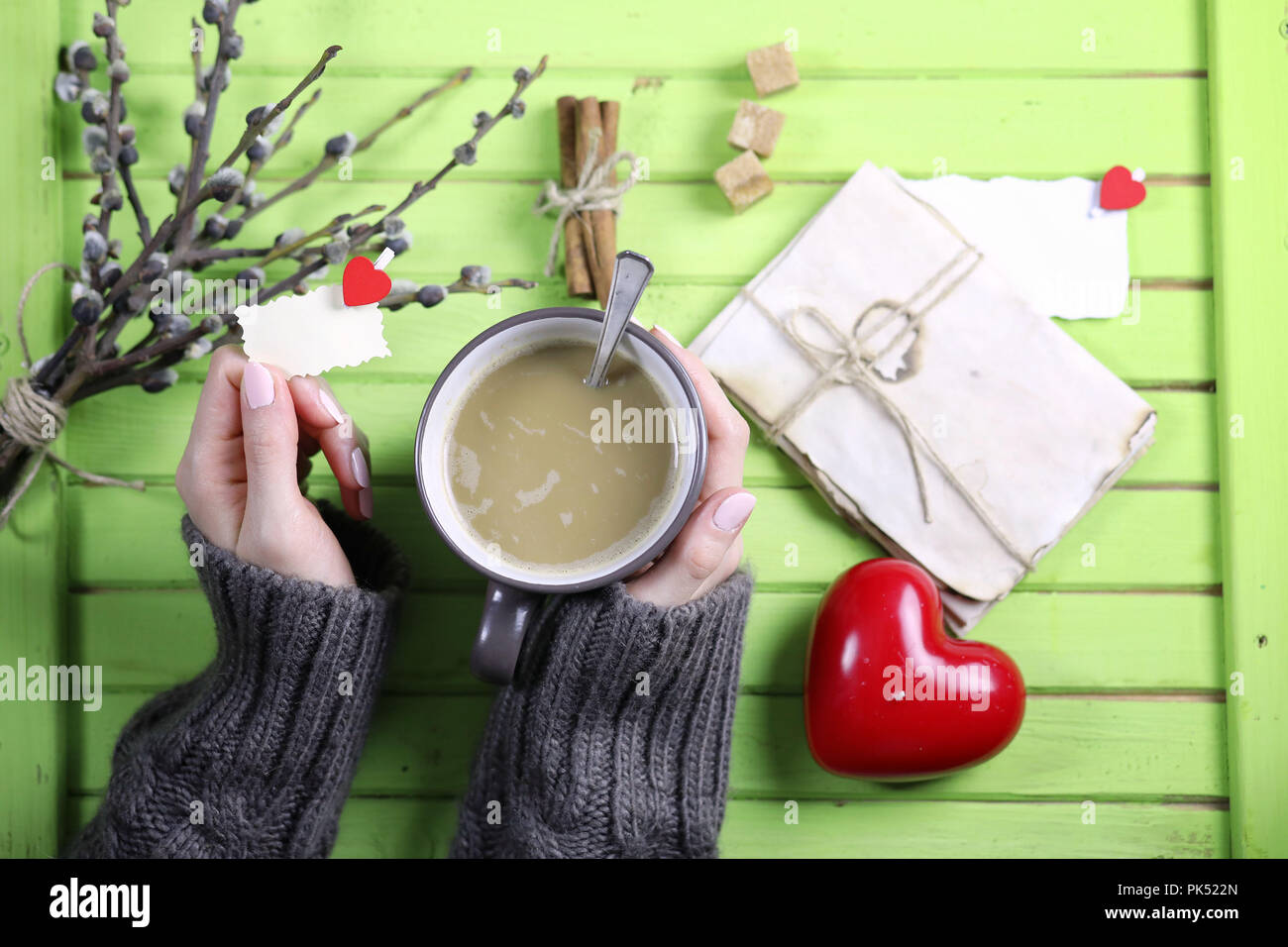 Girl drinking hot coffee and looks presented valentines Stock Photo - Alamy