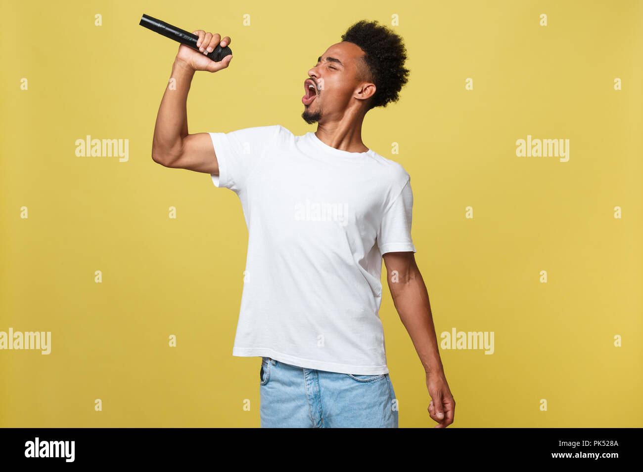 Young handsome African American Male Singer Performing with Microphone ...