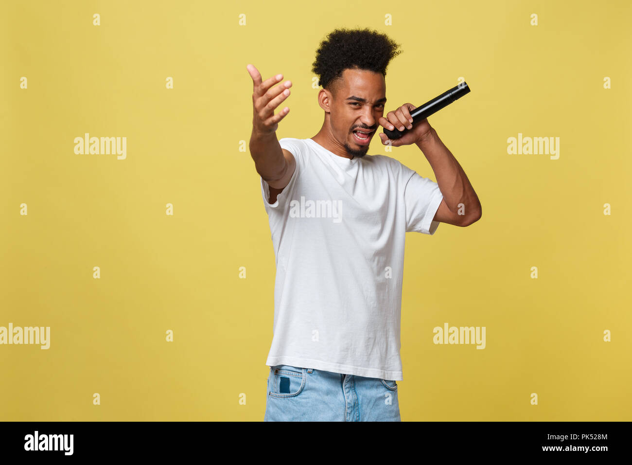 Young handsome African American Male Singer Performing with Microphone ...