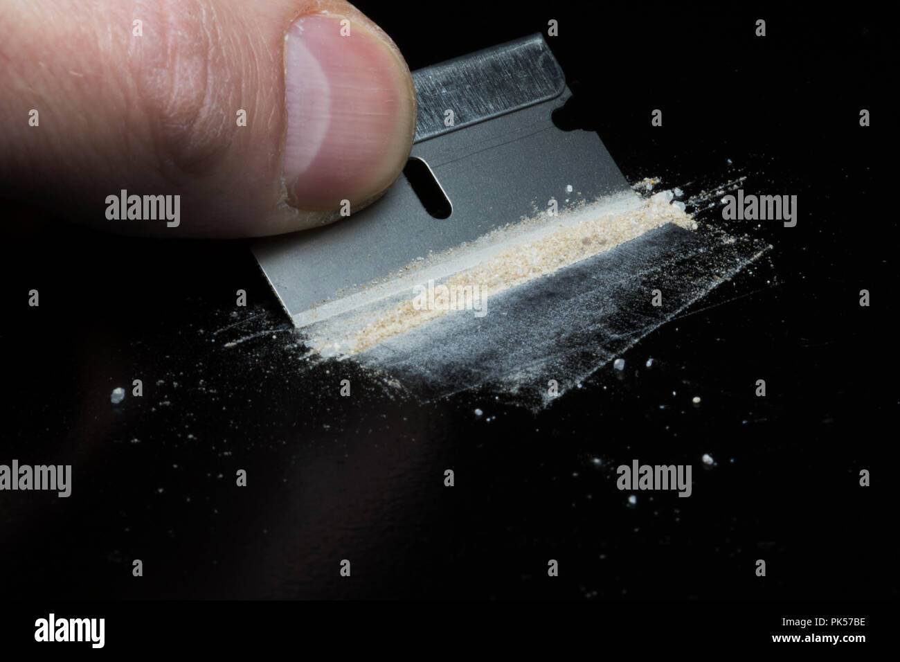 Fentanyl overdose. Razor blade and white powder. Drug use and abuse ...