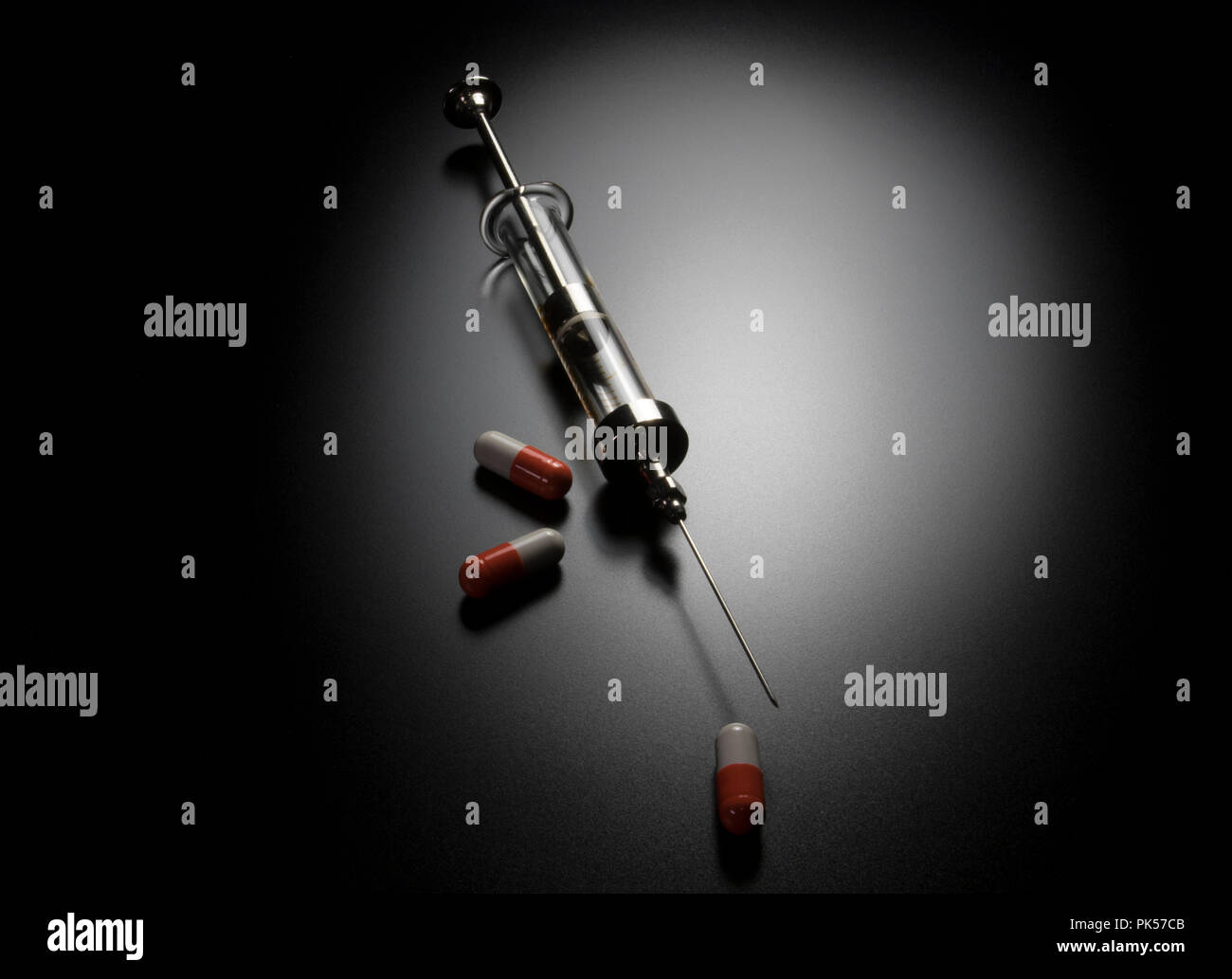 Glass syringe and with tablets of medicine. Pills and needles. Lethal ...