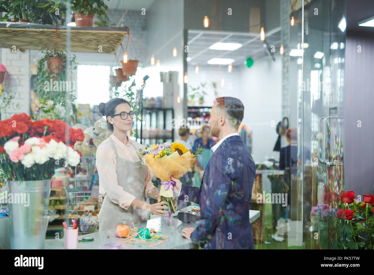 Cheerful florist woman sell flowers hi-res stock photography and images ...