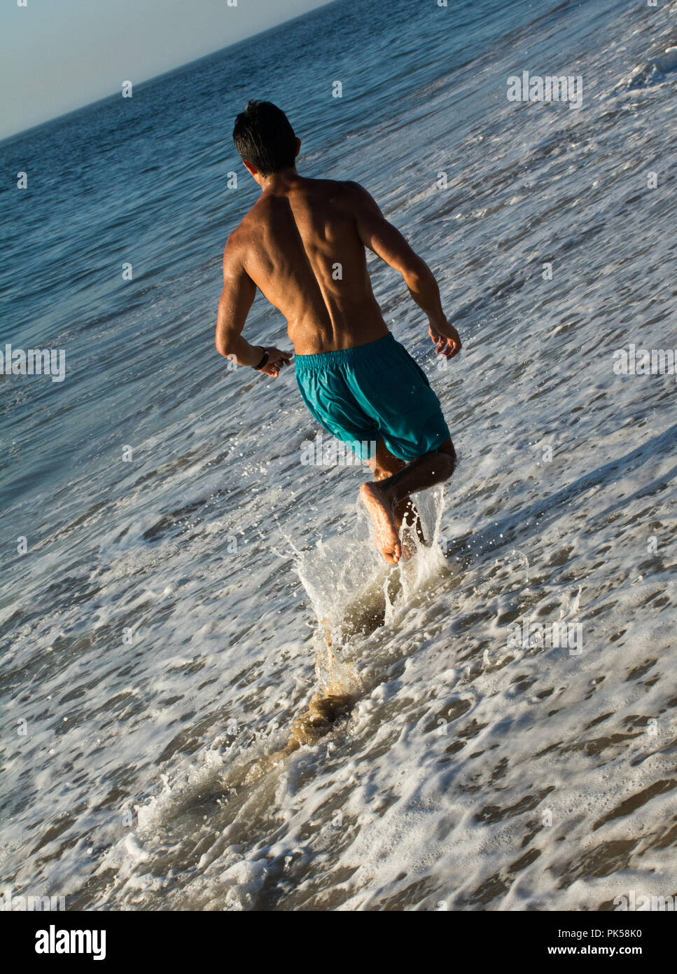 man running on the beach Stock Photo - Alamy