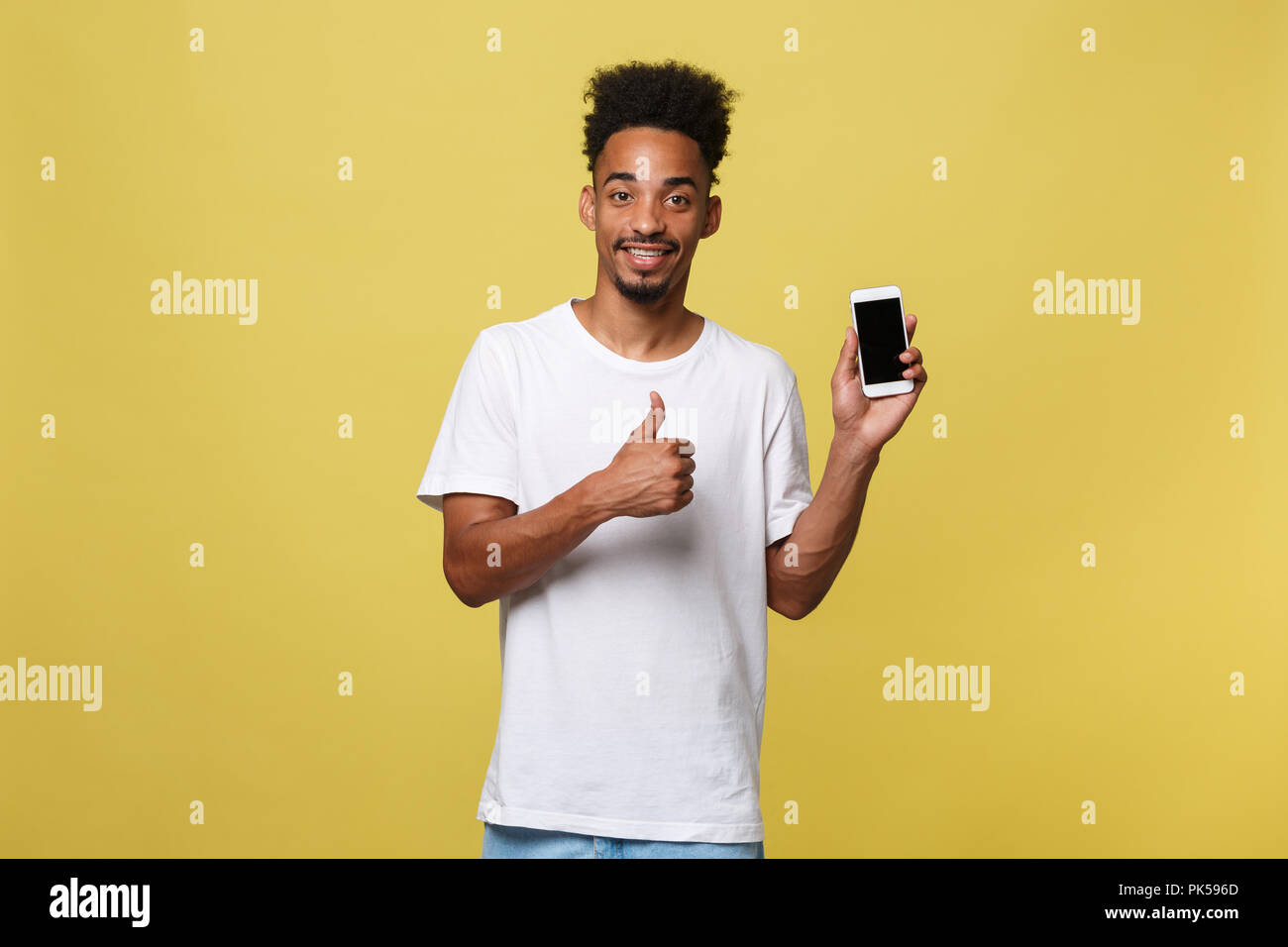 Portrait of attractive young black man isolated on yellow background ...