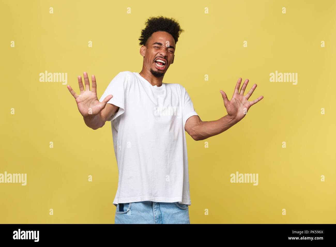 Portrait furious angry annoyed displeased young man raising hands up to ...
