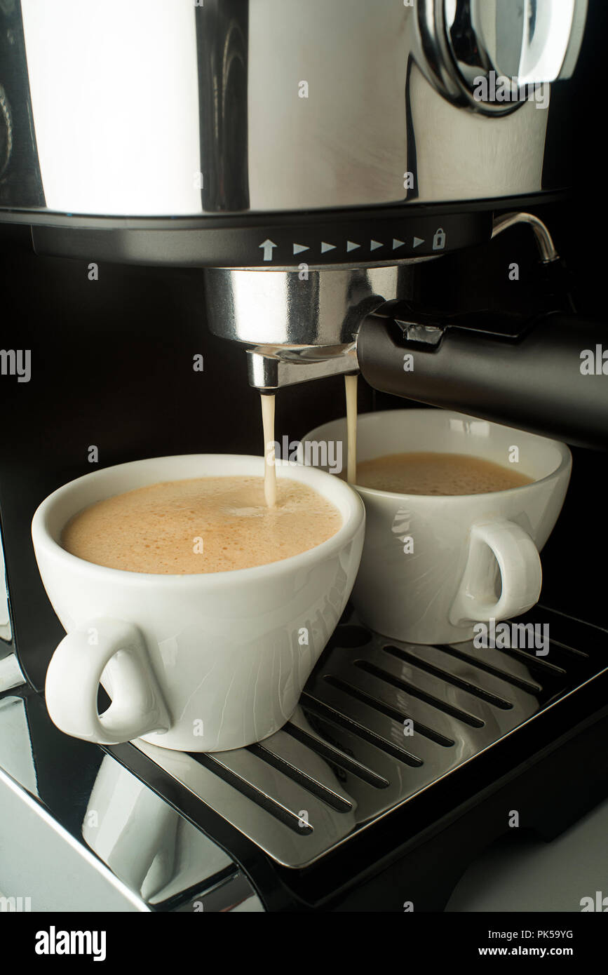 Espresso coffee pouring from coffee machine. Professional coffee ...