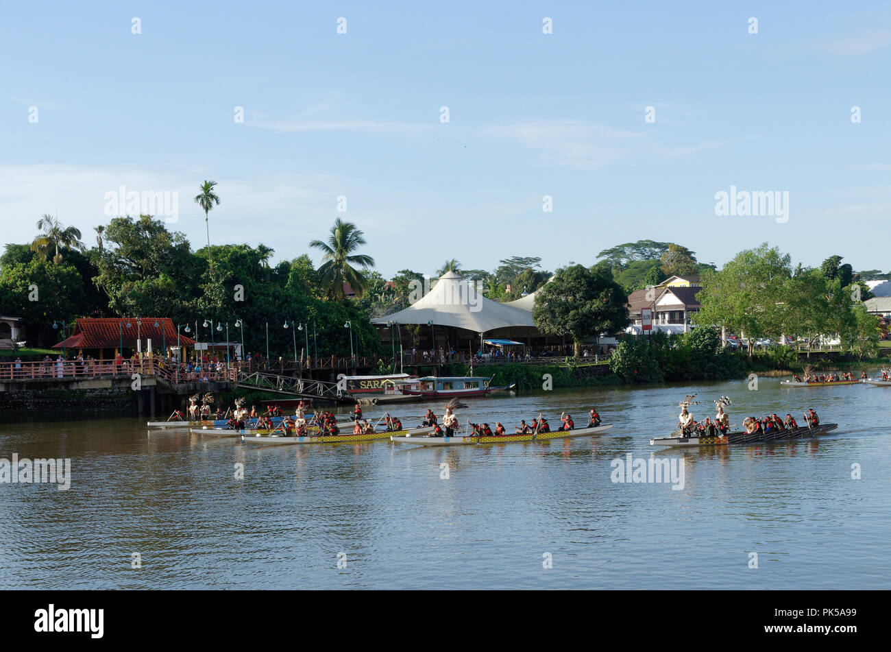 Kuching, Sarawak river, boats with natives in traditional dress form ...