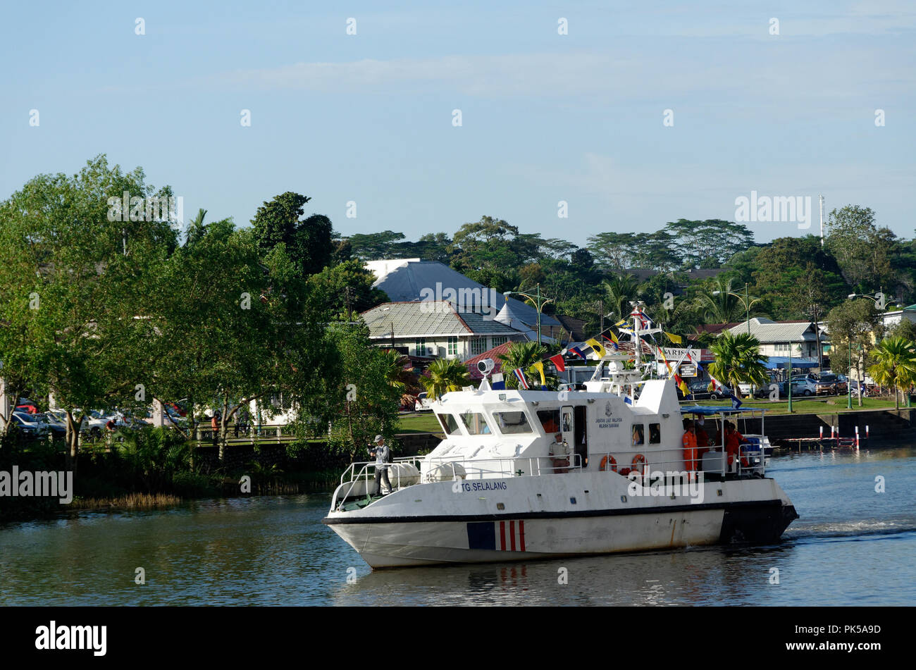 Kuching, Sarawak river, boats with natives in traditional dress form ...