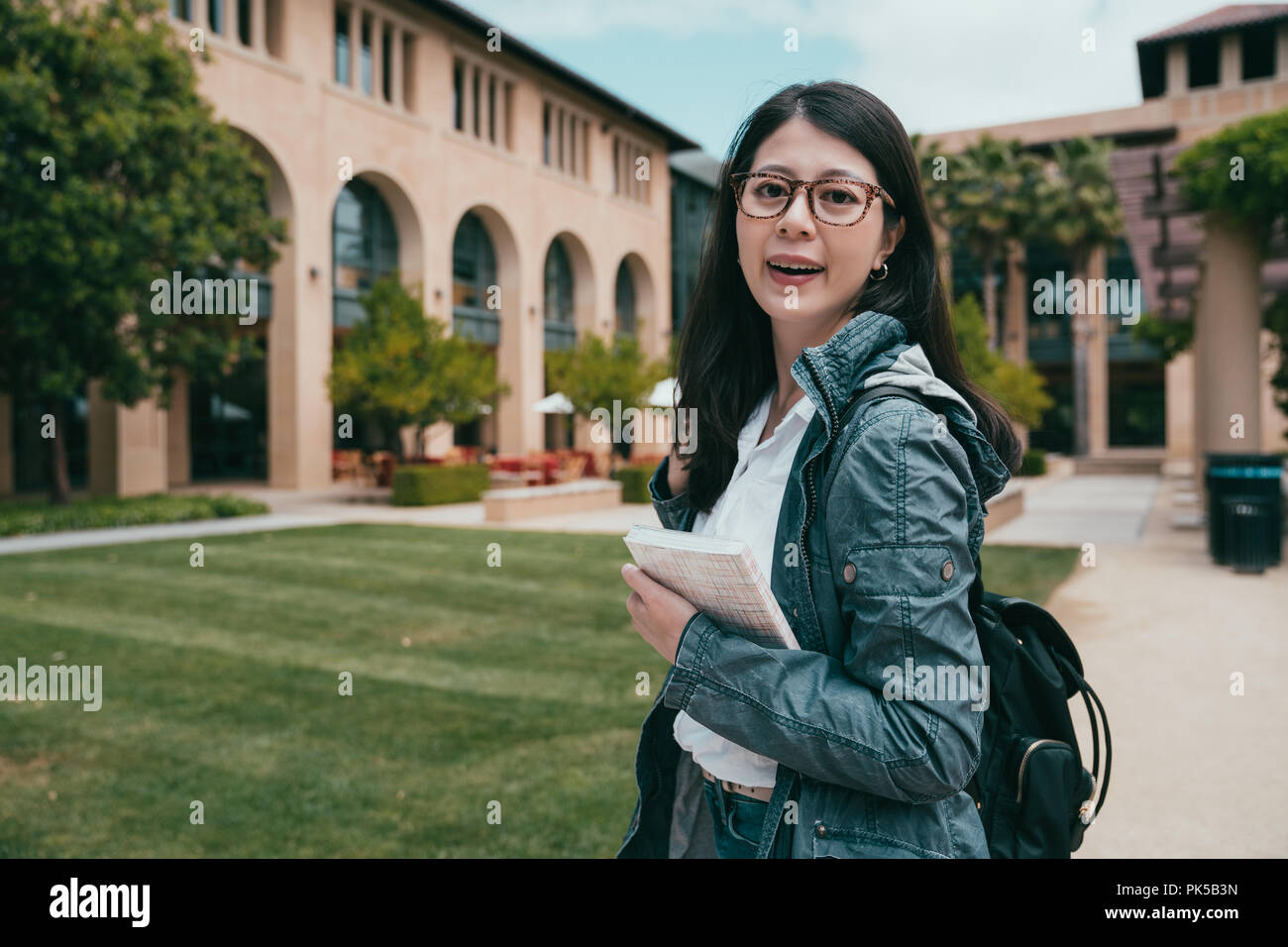female international student looking happily and heading to her ...