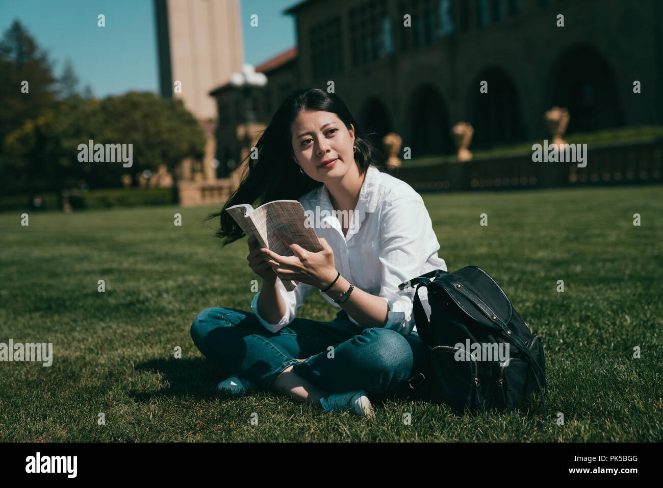 a smart international student reading her novel and sitting on the ...
