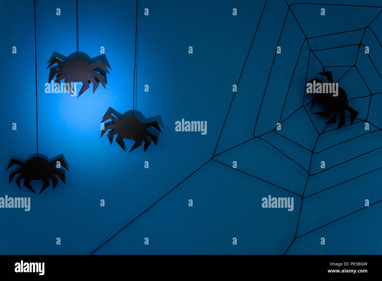 Black paper spider with web on dark blue background. Halloween concept ...