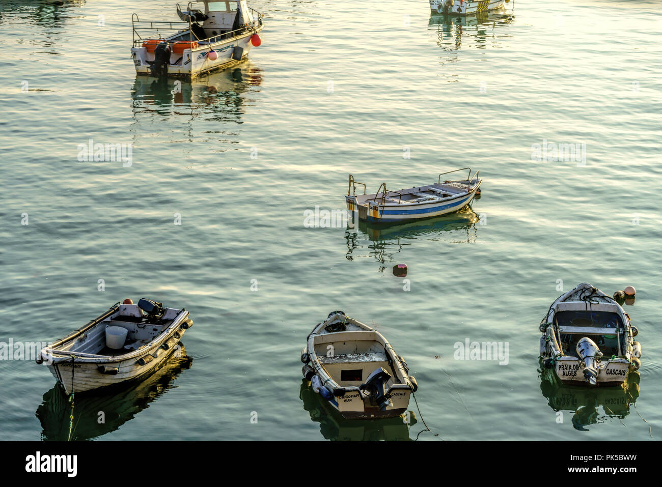 Small fishing boats floating in the fish port of Cascais - Portugal ...