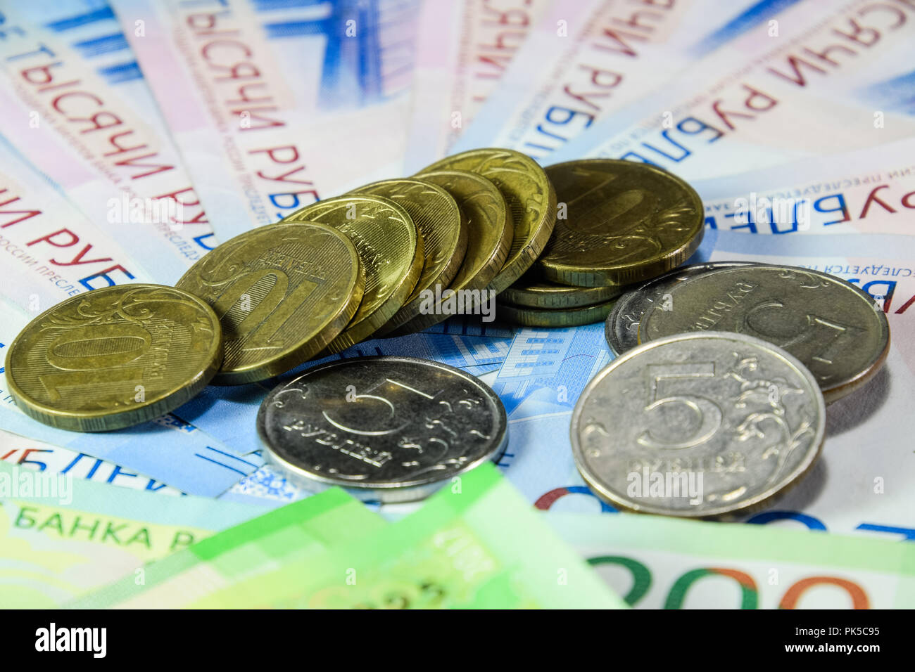 Russian banknotes and coins. A handful of coins on new Russian ...