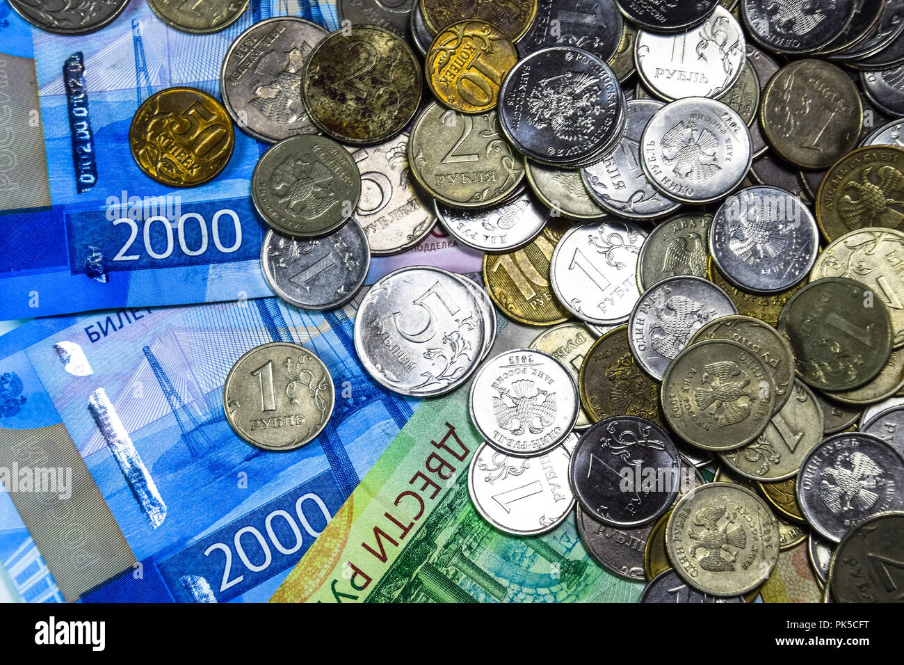 Russian banknotes and coins. A handful of coins on new Russian ...