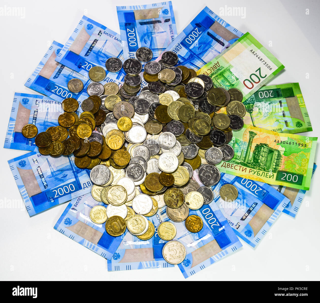 Russian banknotes and coins. A handful of coins on new Russian ...