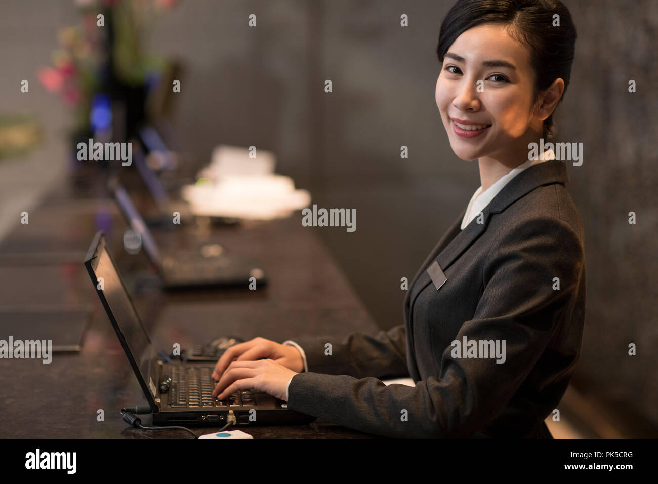 Hotel receptionist smile young woman hi-res stock photography and ...