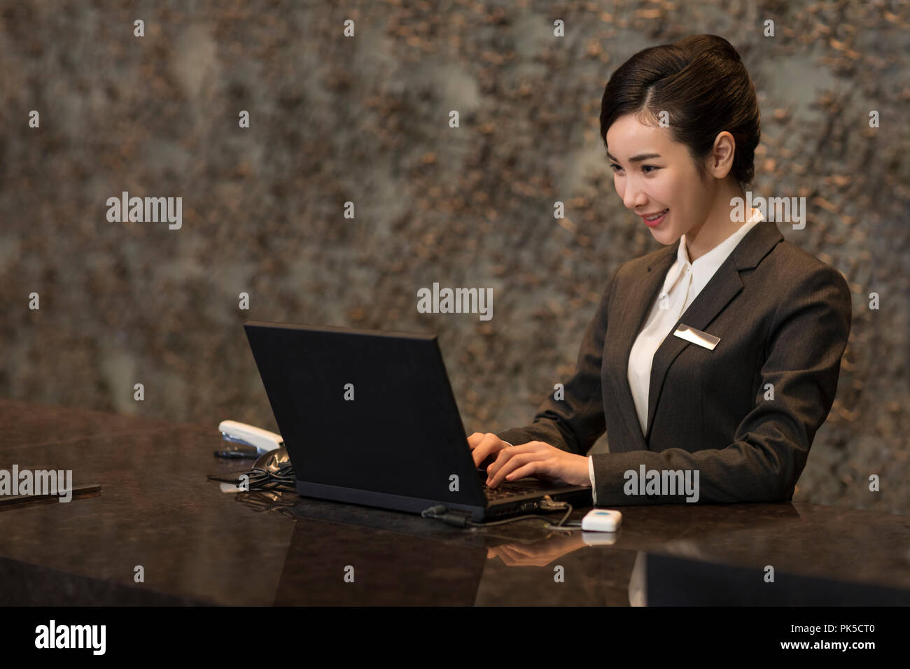 Chinese woman hotel receptionist hi-res stock photography and images ...