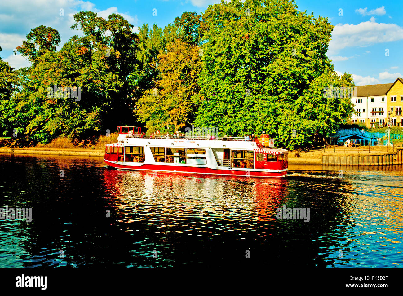 Sightseeing boat on River Ouse heading toward Skeldergate Bridge, York ...