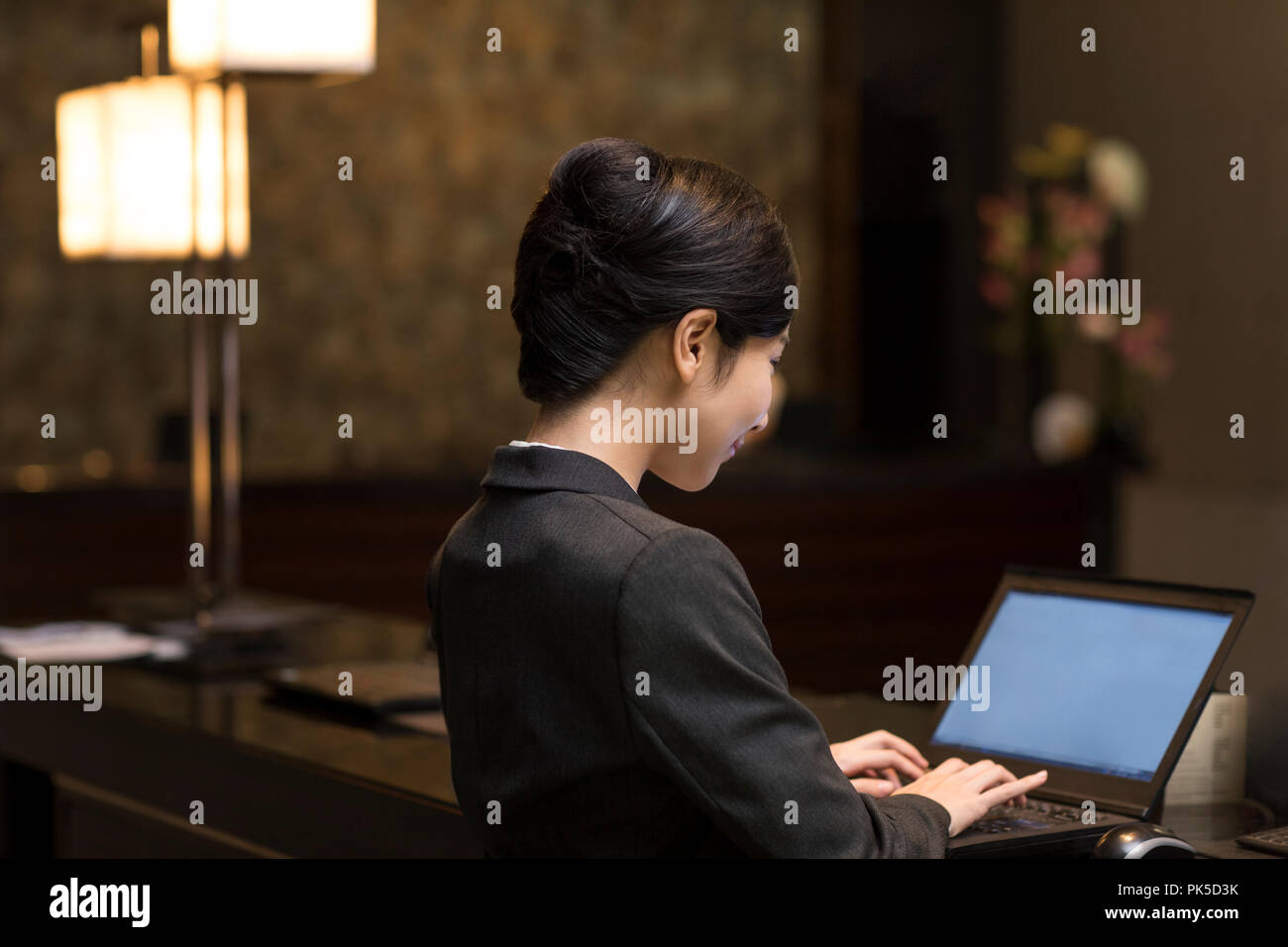Chinese woman hotel receptionist hi-res stock photography and images ...
