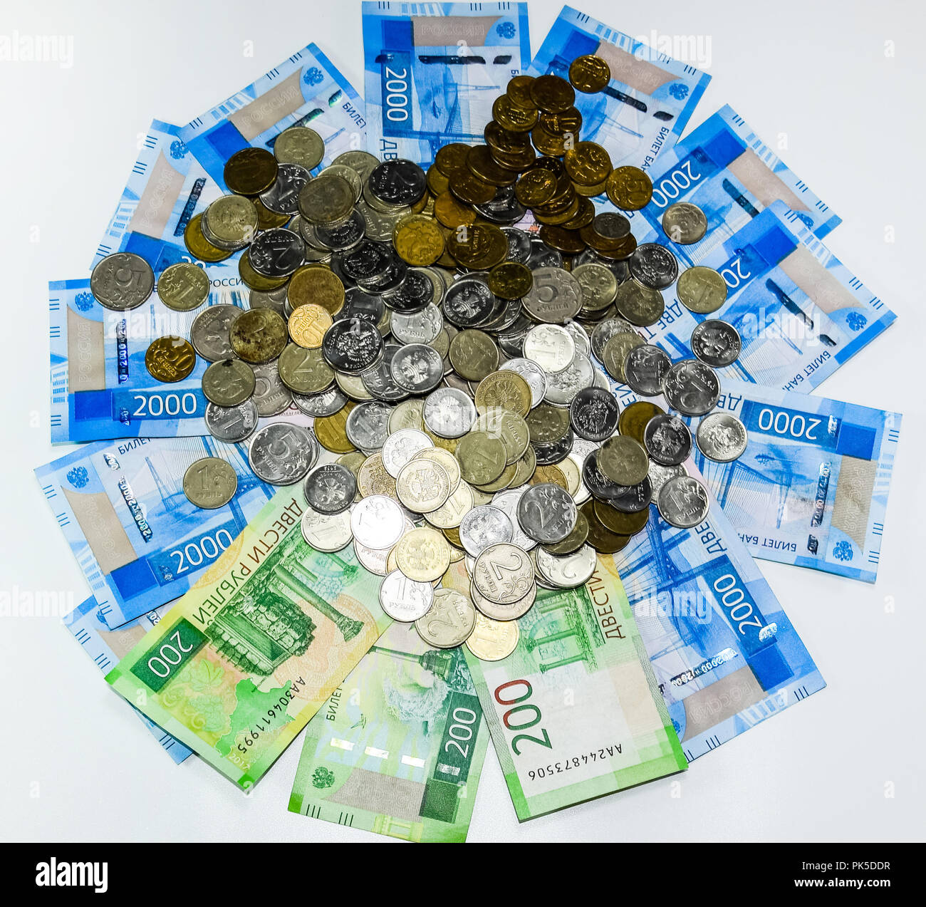 Russian banknotes and coins. A handful of coins on new Russian ...
