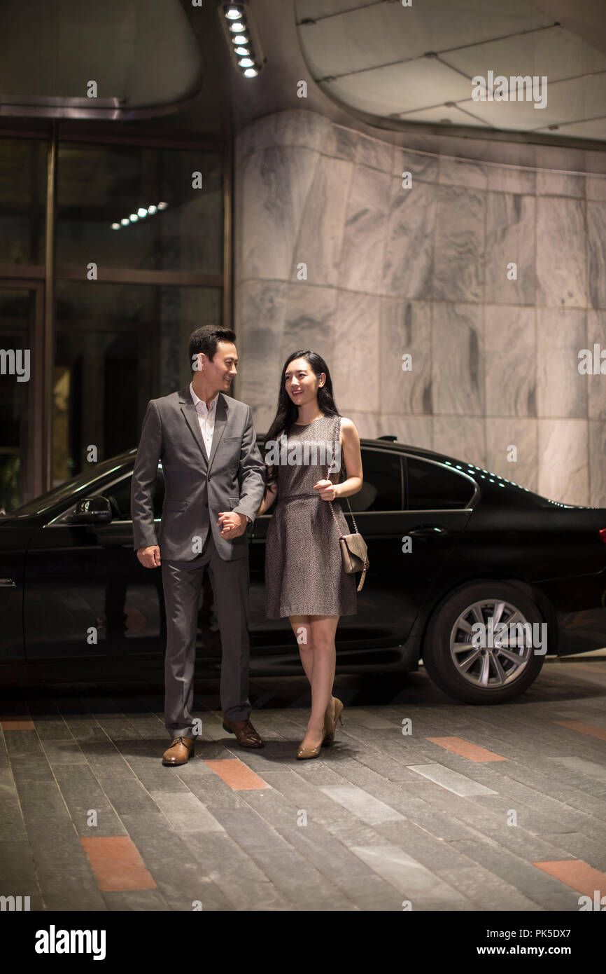 Cheerful young couple arriving at hotel by car Stock Photo - Alamy