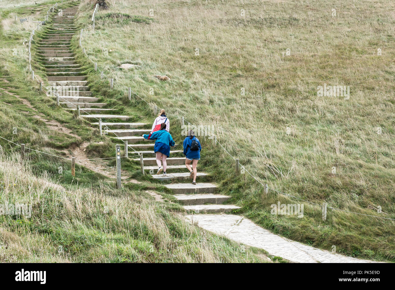 Female walking up steps hi-res stock photography and images - Alamy