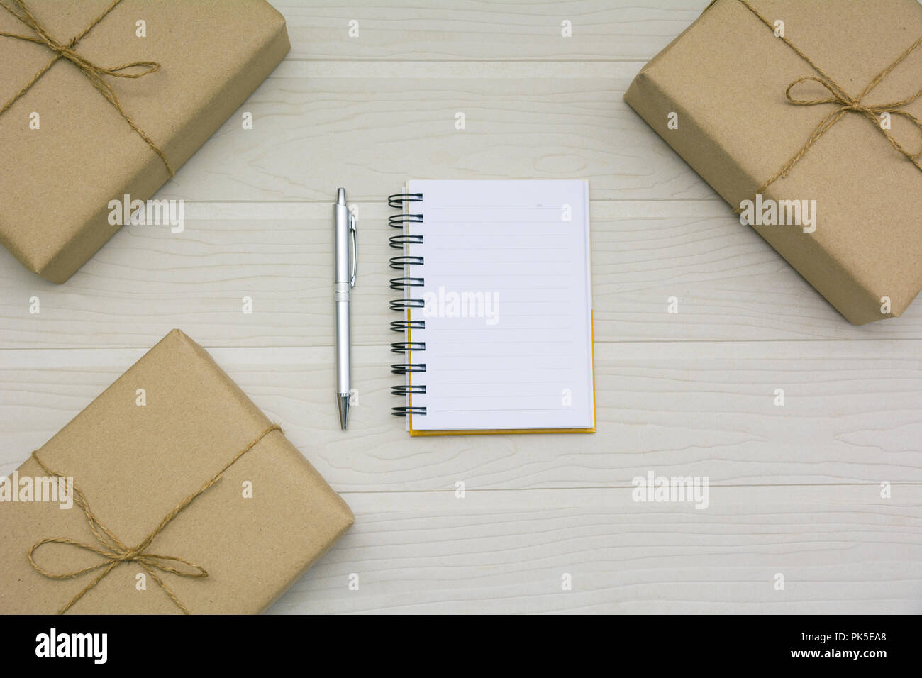Top view of open book. Book open with pen and boxes on wooden ...