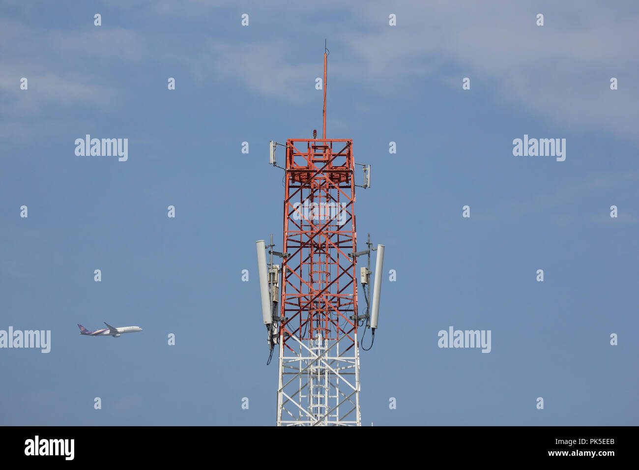 Mobile phone tower with airplane background Stock Photo - Alamy