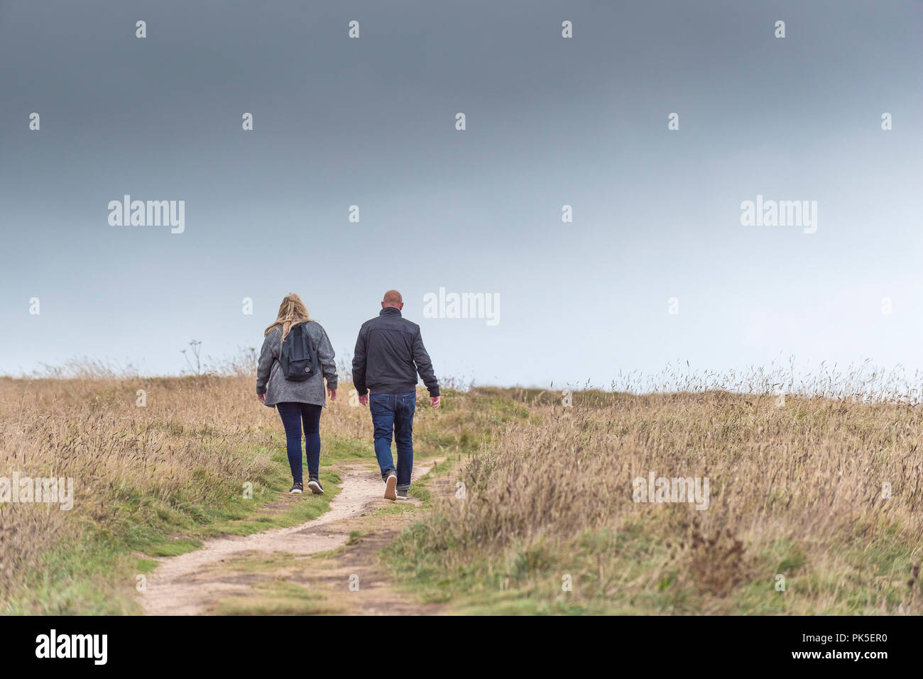 Couple walking along a footpath hi-res stock photography and images - Alamy
