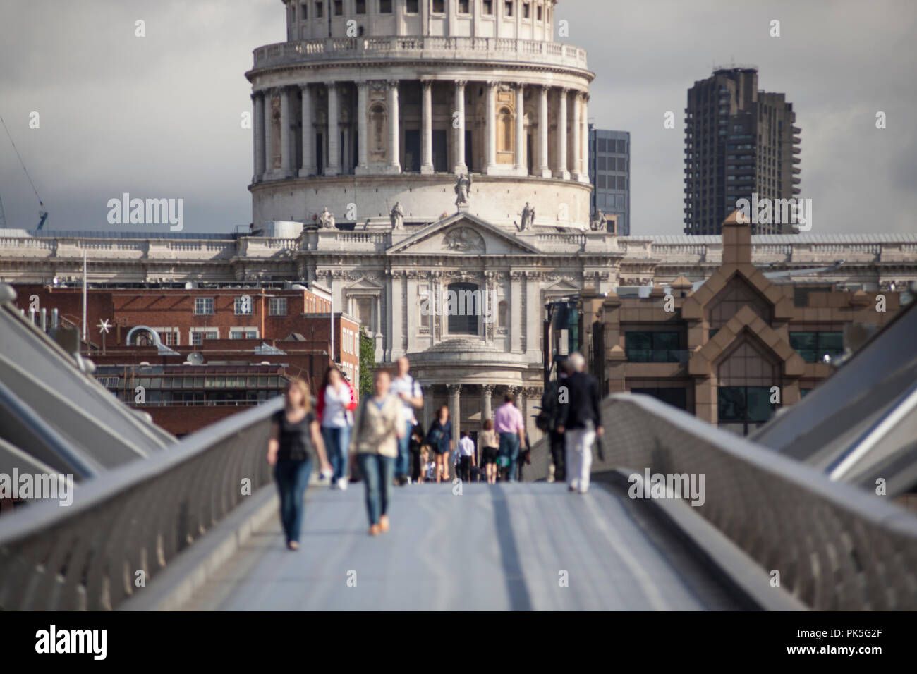 Millennium Bridge looking toward St Paul's Cathedral. People walk over ...