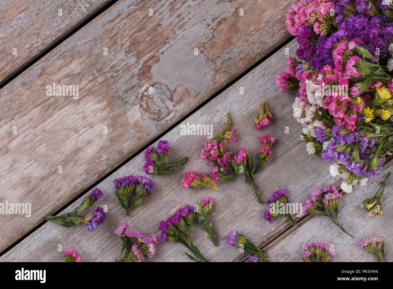 Statice limonium flowers scattered on the table. Copyspace, free space ...