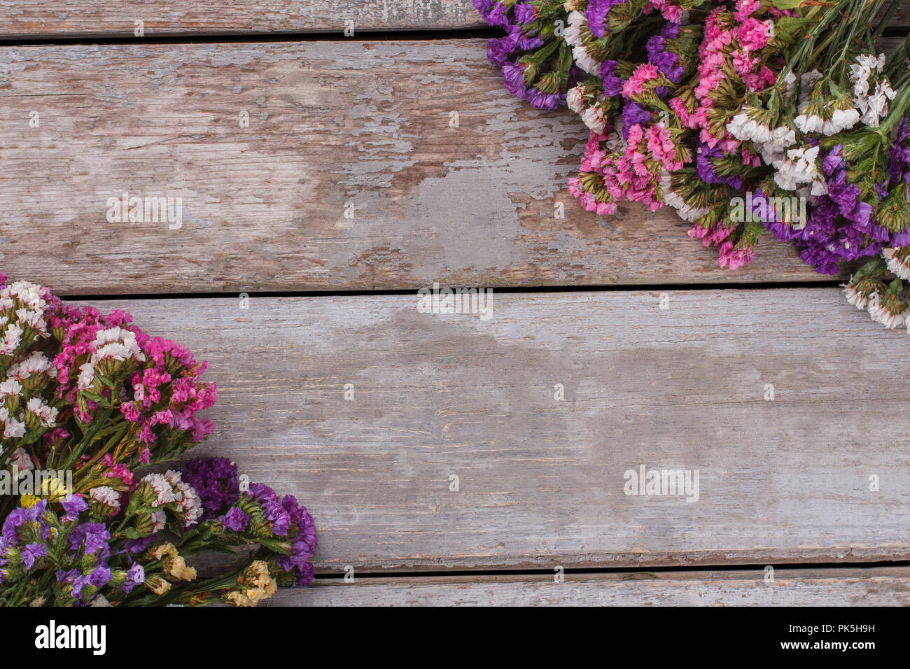 Statice mix color limonium sinuatum flowers. Old vintage wooden desk ...