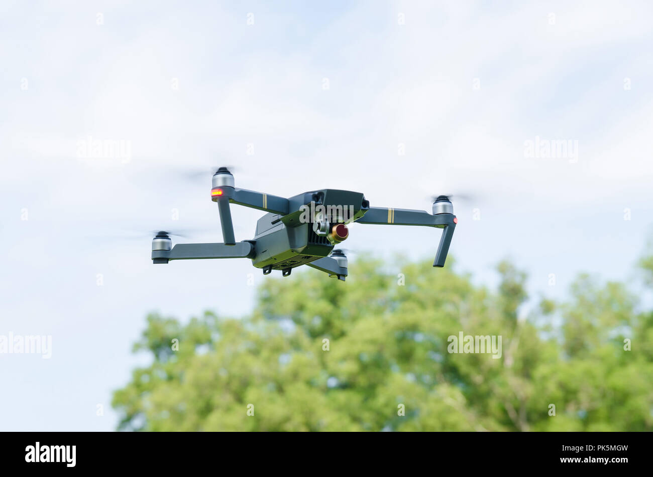 The drone hovering in a bright blue sky Stock Photo - Alamy