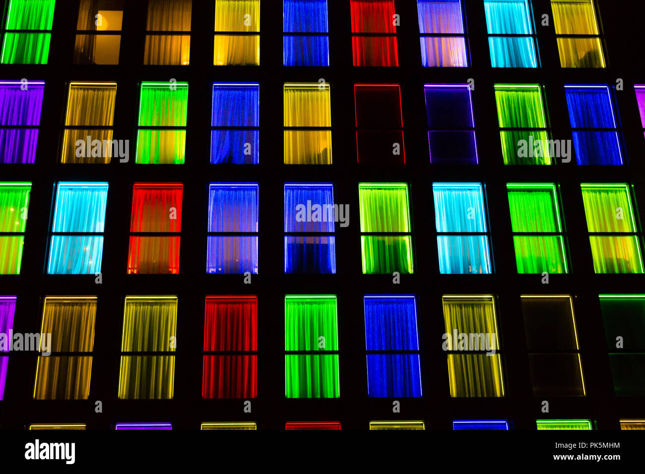 Colored windows texture. Windows illuminated by neon lights background ...