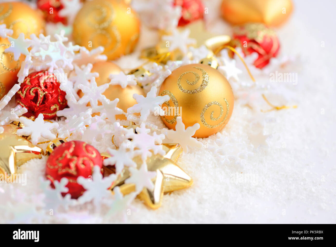 Christmas gold and red ornaments on the snow. Festive Christmas ...