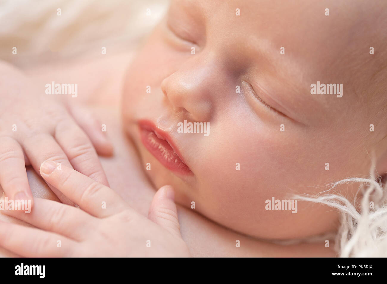 Newborn baby girl sleeping on a fluff Stock Photo - Alamy