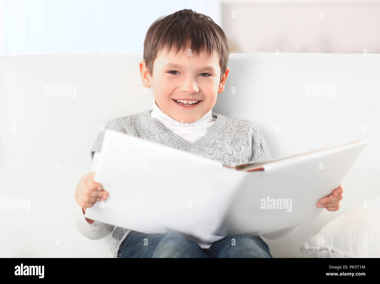 smiling boy reading a book in the nursery.photo with copy space Stock ...