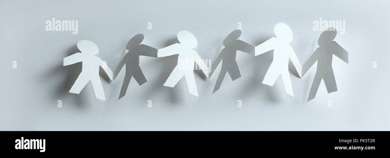 group of paper men holding each other's hands Stock Photo - Alamy