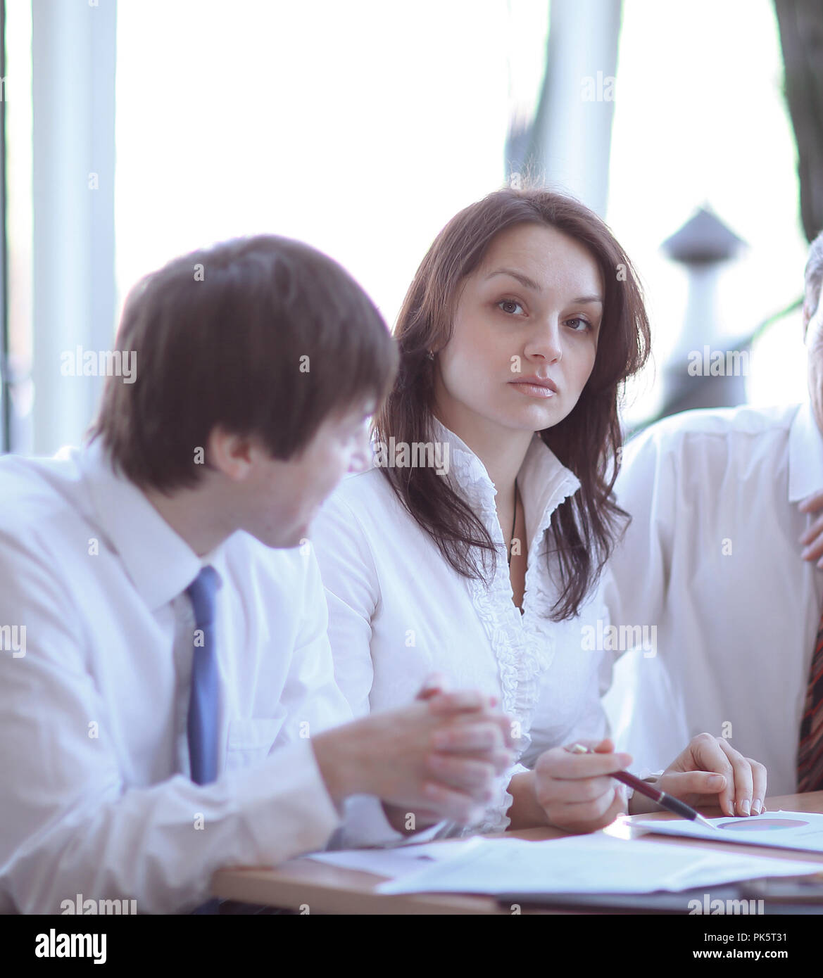 business colleagues analyzing financial statistics sitting at a Desk ...