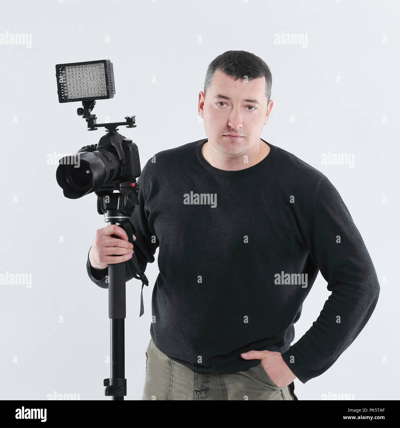 professional photographer standing near the tripod.isolated on white ...