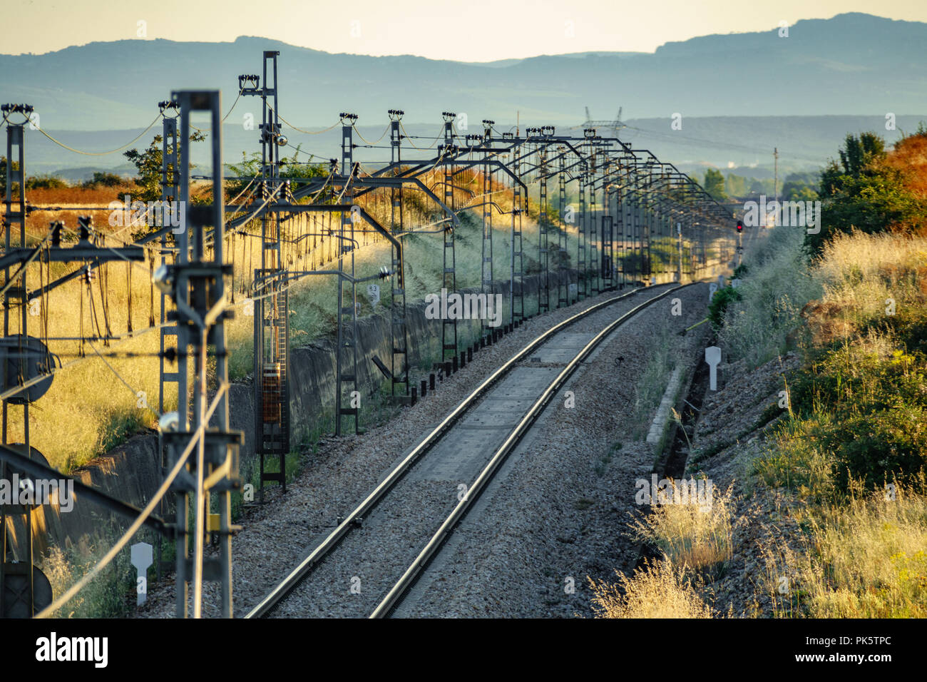 Profile view of train line towards mountains Stock Photo - Alamy