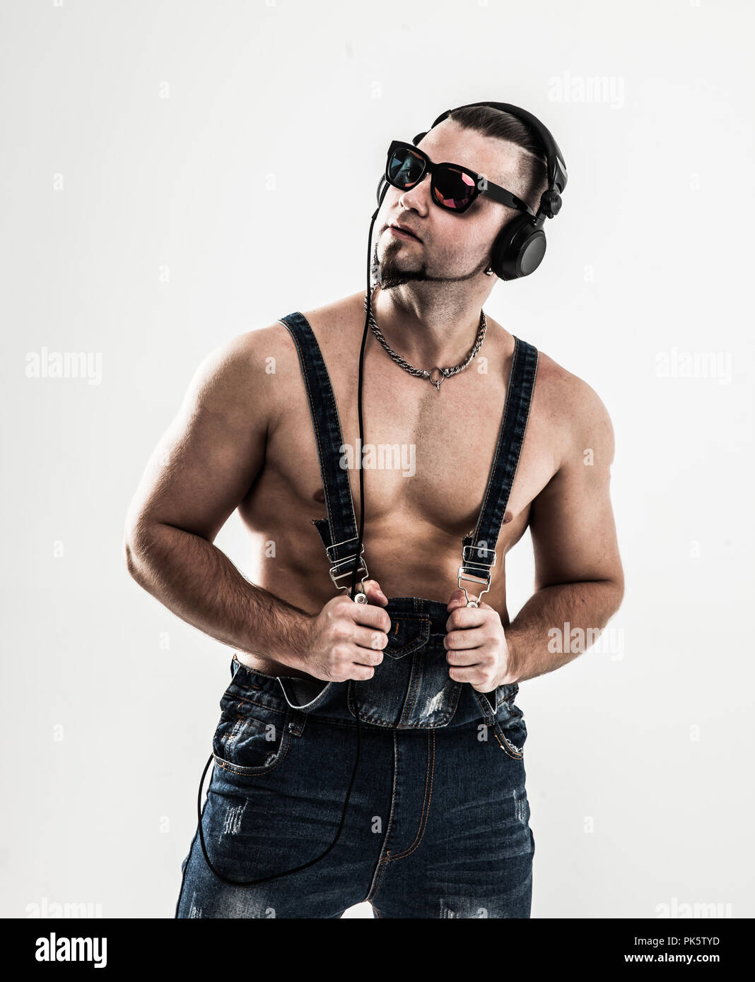 emotional and charismatic DJ - rapper with headphones on a light Stock ...