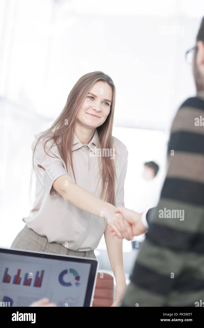 close up. the handshake of employee and customer in a modern office ...