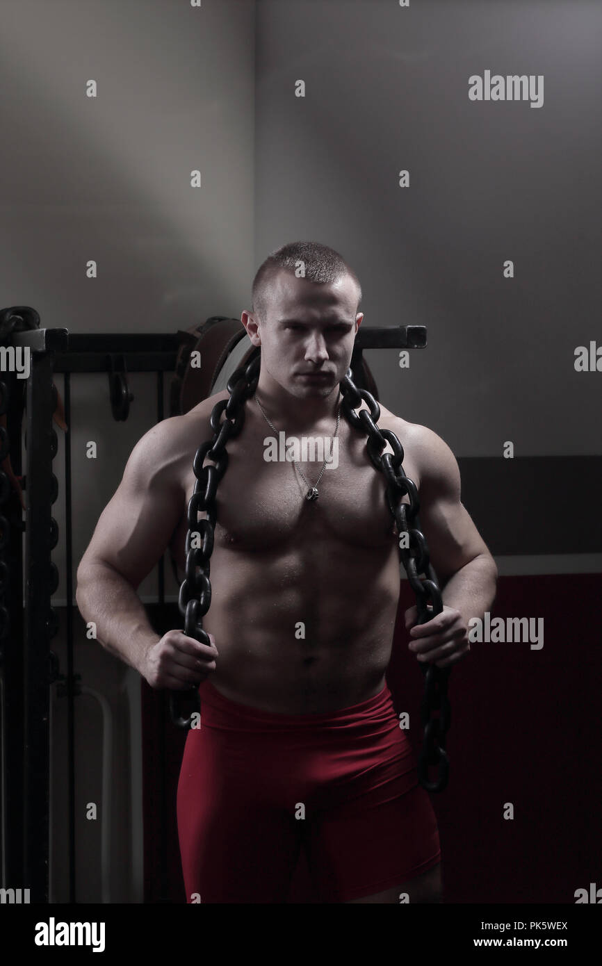 portrait of a handsome male bodybuilder with a chain around his neck ...
