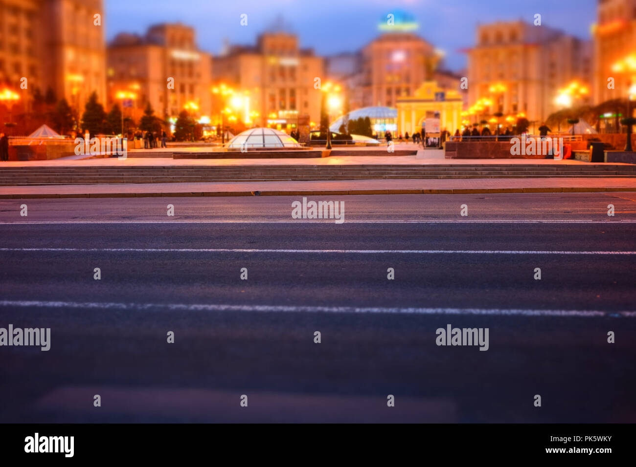 Night city street with approaching cars on the road, close up view from ...