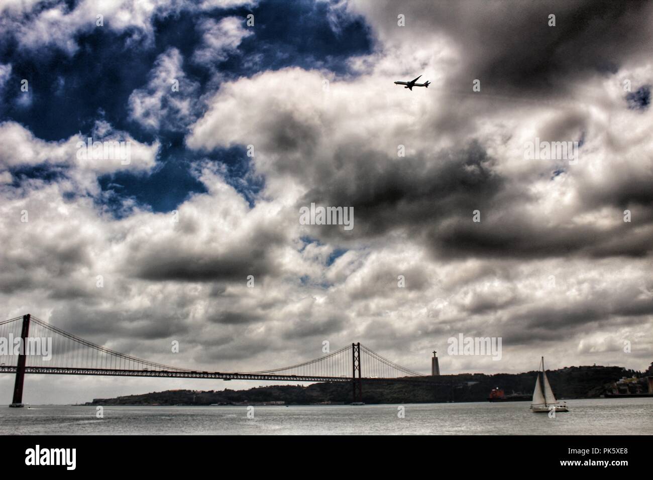 Banks of the river Tagus in Lisbon in Spring on a cloudy day. Beautiful 25th April bridge ...