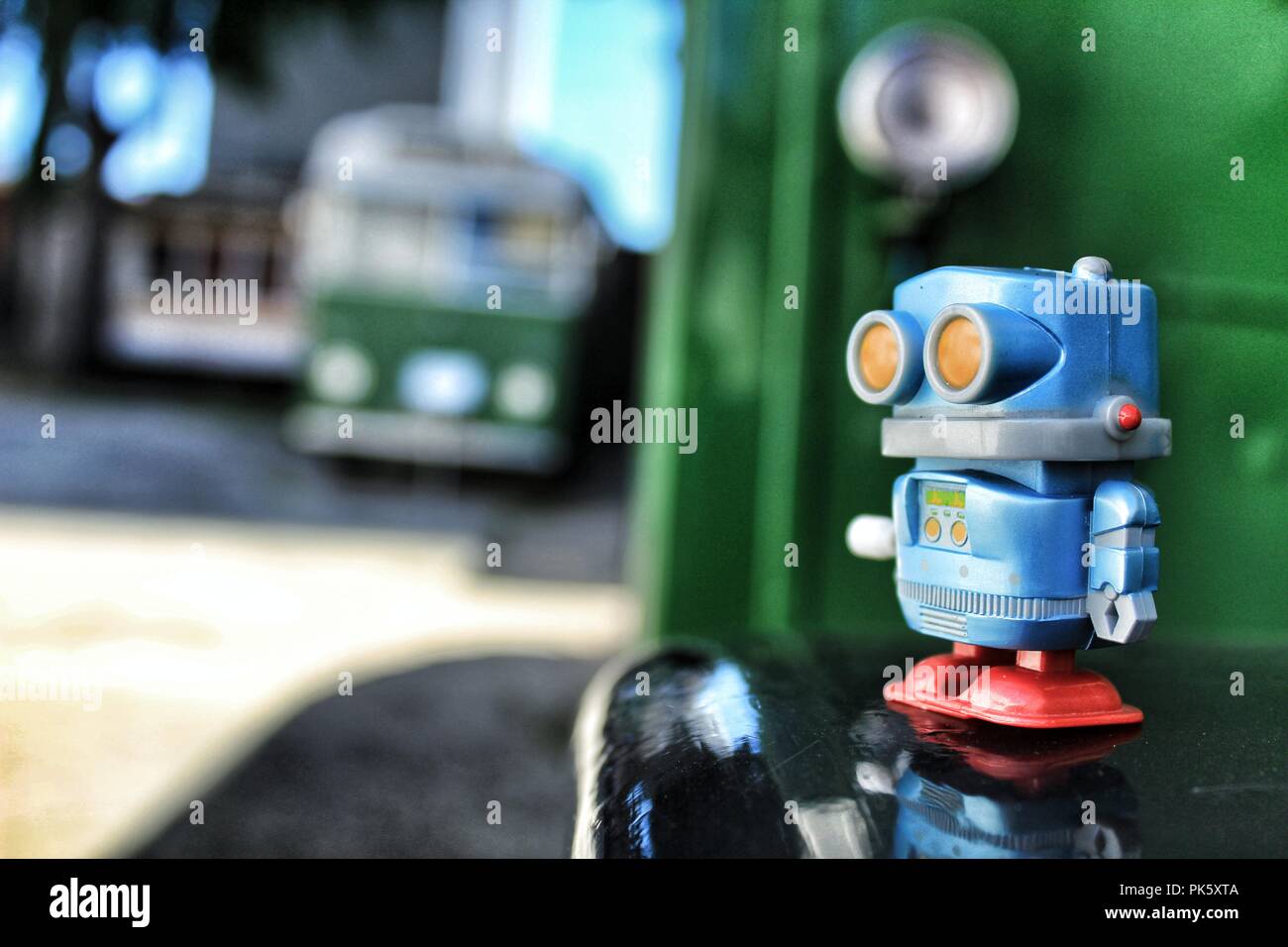 Toy robot on old bus school. Green color in the background Stock Photo ...